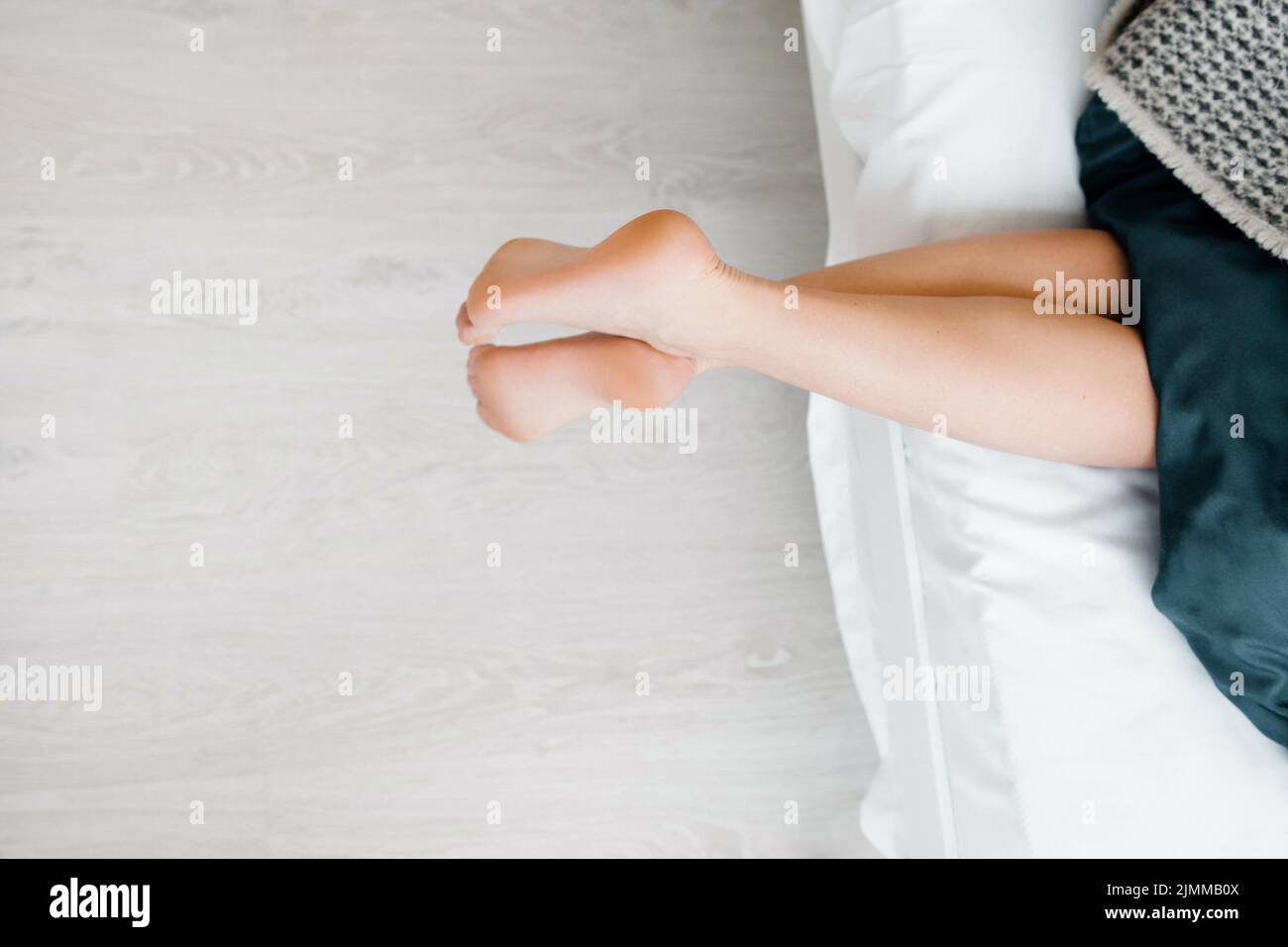 Legs hung down from bed flat lay Stock Photo - Alamy