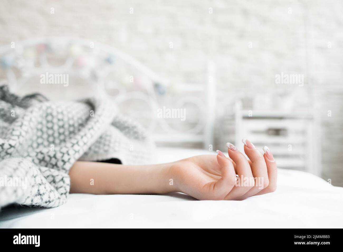 Hand of sleeping in bed covered woman closeup Stock Photo - Alamy