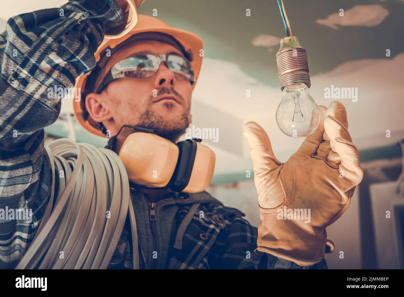 Caucasian Professional Electrician Testing Newly Installed Lighting ...