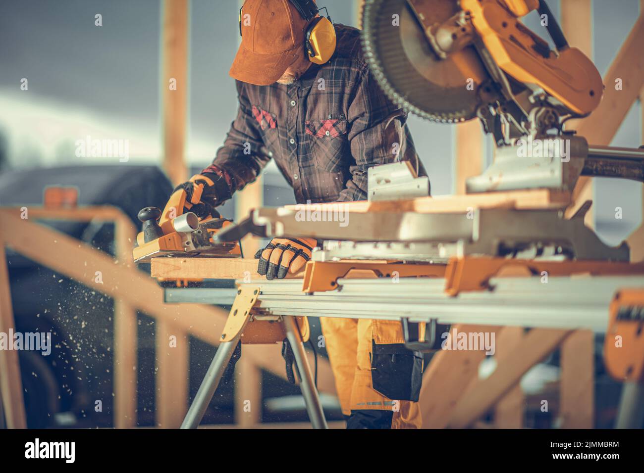 Carpentry Construction Worker Planing the Wood Using Electric Planer ...