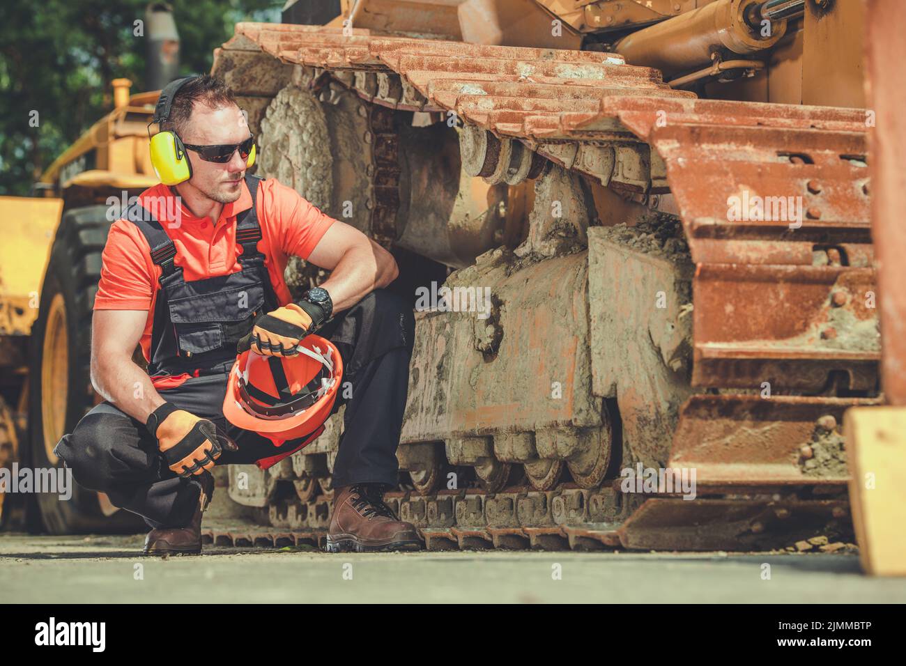 Caucasian Construction Worker Wearing Noise Reduction Headphones and ...
