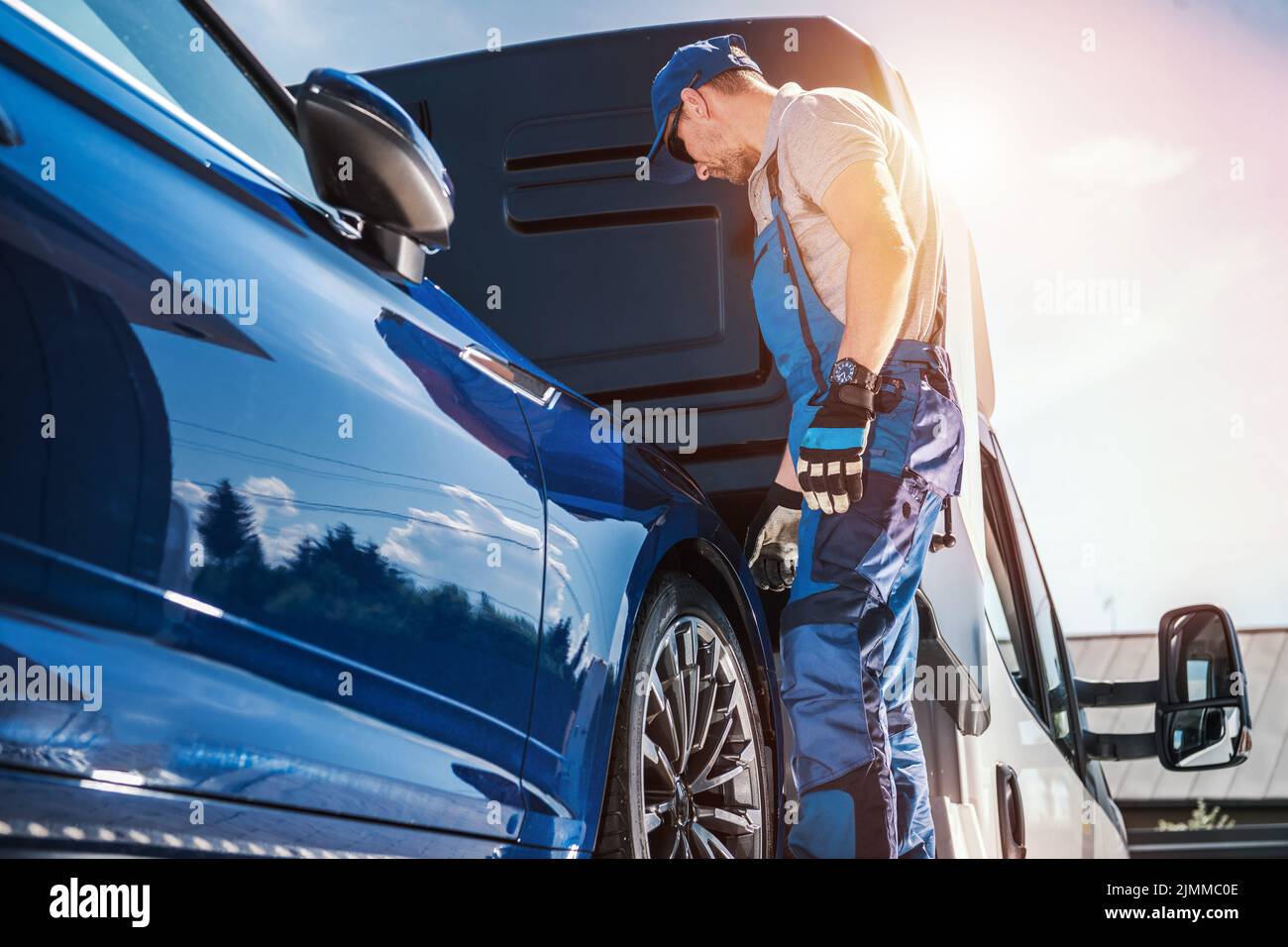 Caucasian Tow Truck Driver in Blue Work Uniform Making Final Safety ...
