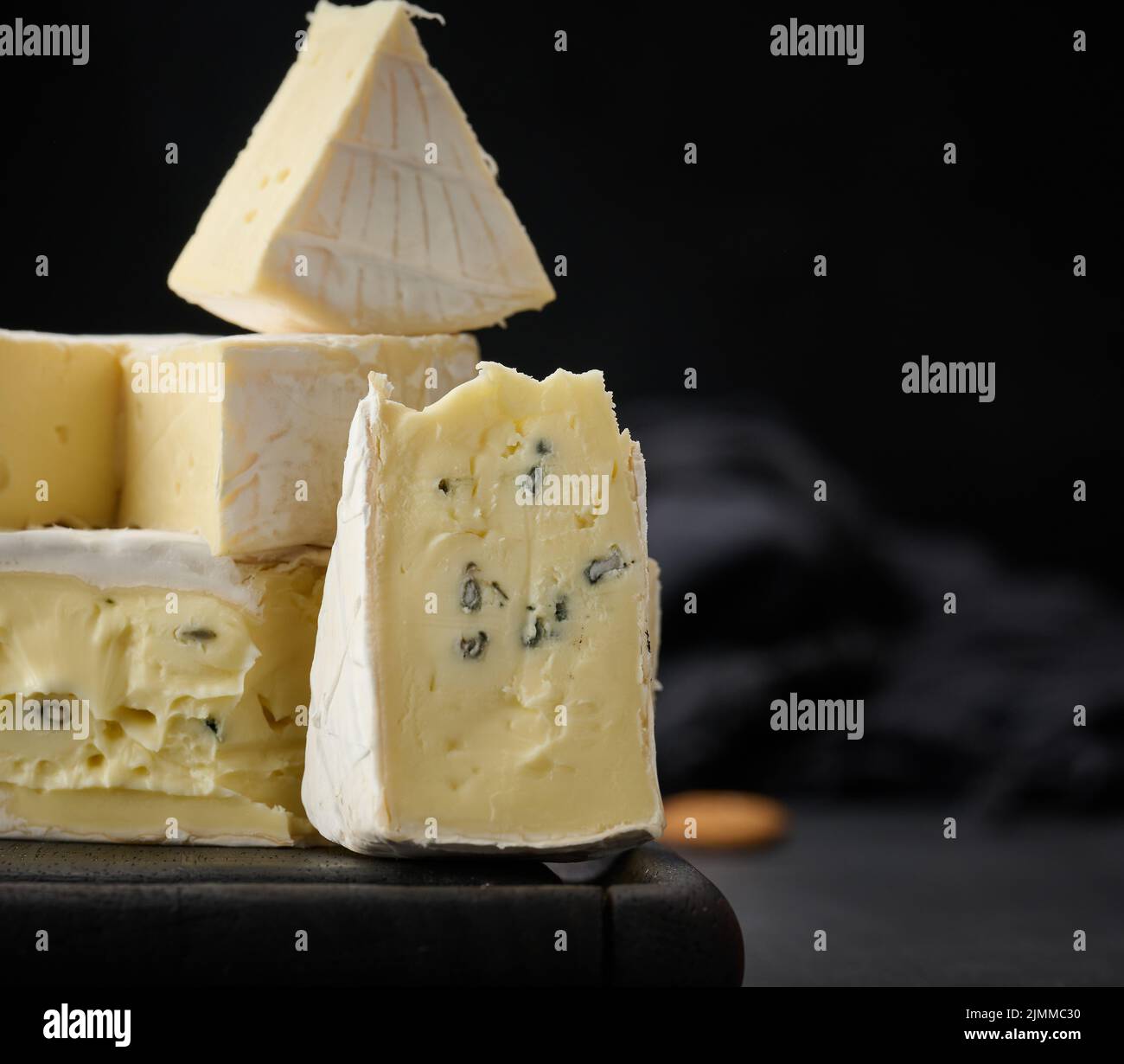Brie and bergader blue cheese on a brown wooden board, delicious snack ...