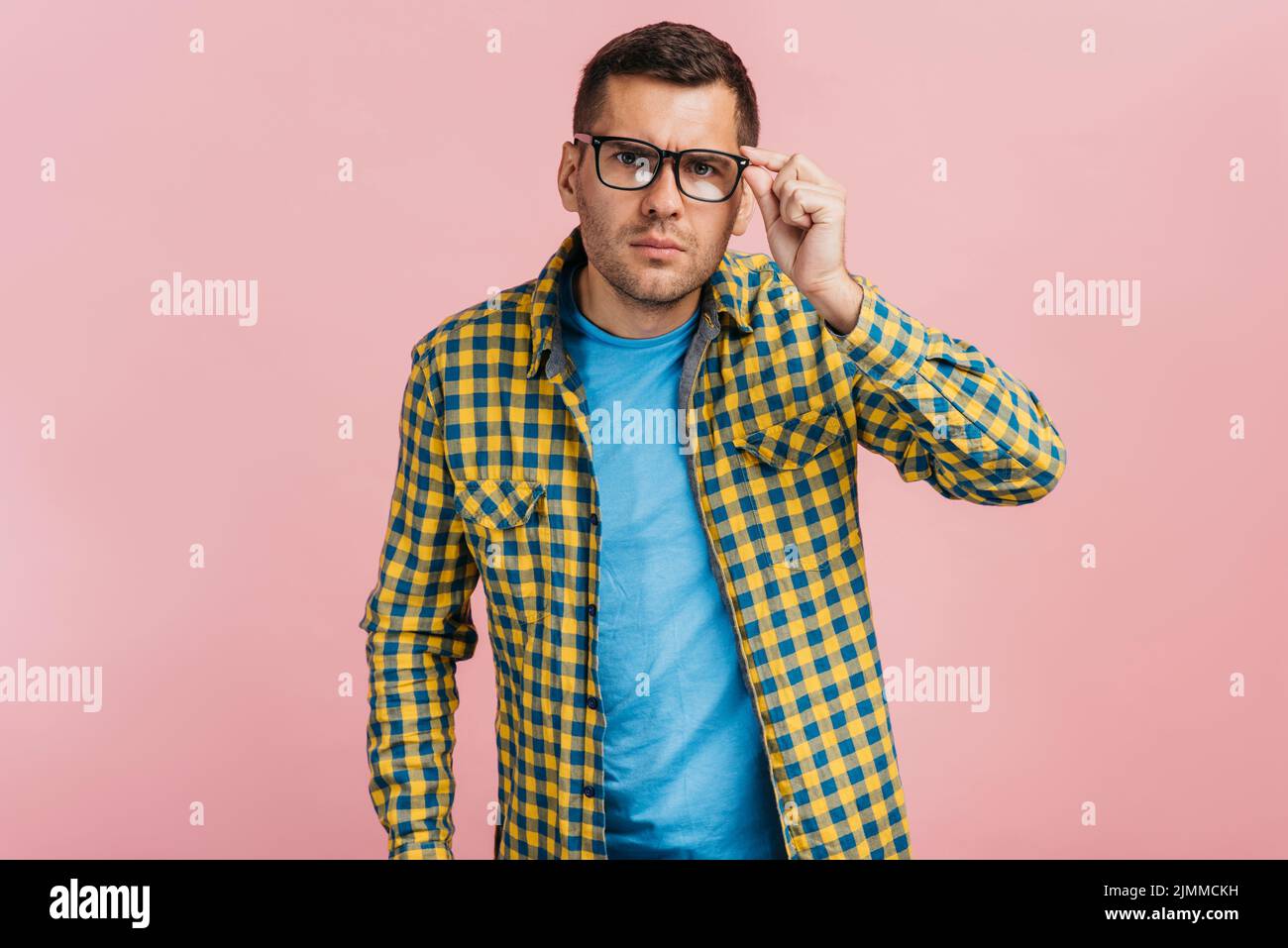 Man with glasses looking curious Stock Photo - Alamy