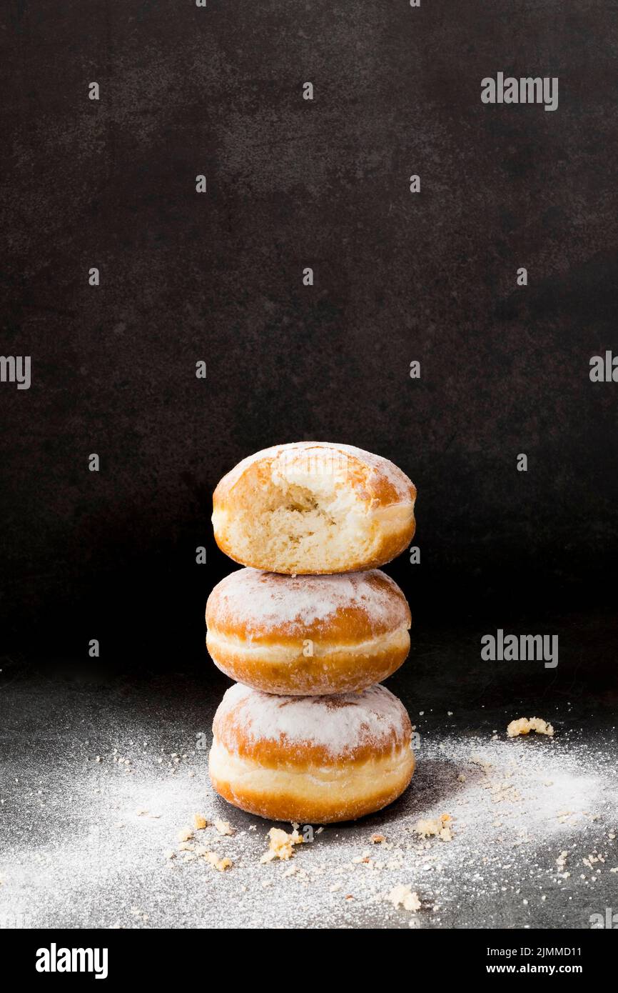 High angle stacked donuts with powdered sugar Stock Photo - Alamy