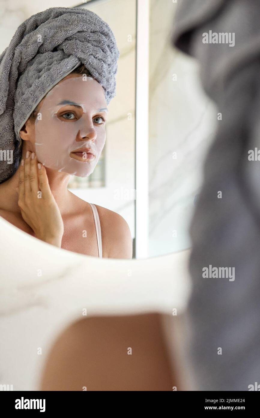 Beautiful woman with applied sheet mask on her face Stock Photo - Alamy
