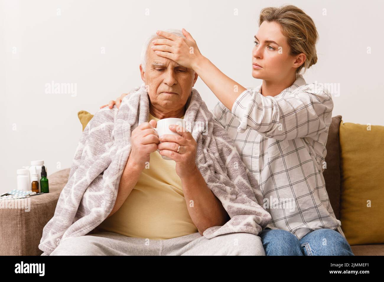 Woman taking care of her elderly grandfather with a cold syptoms Stock ...