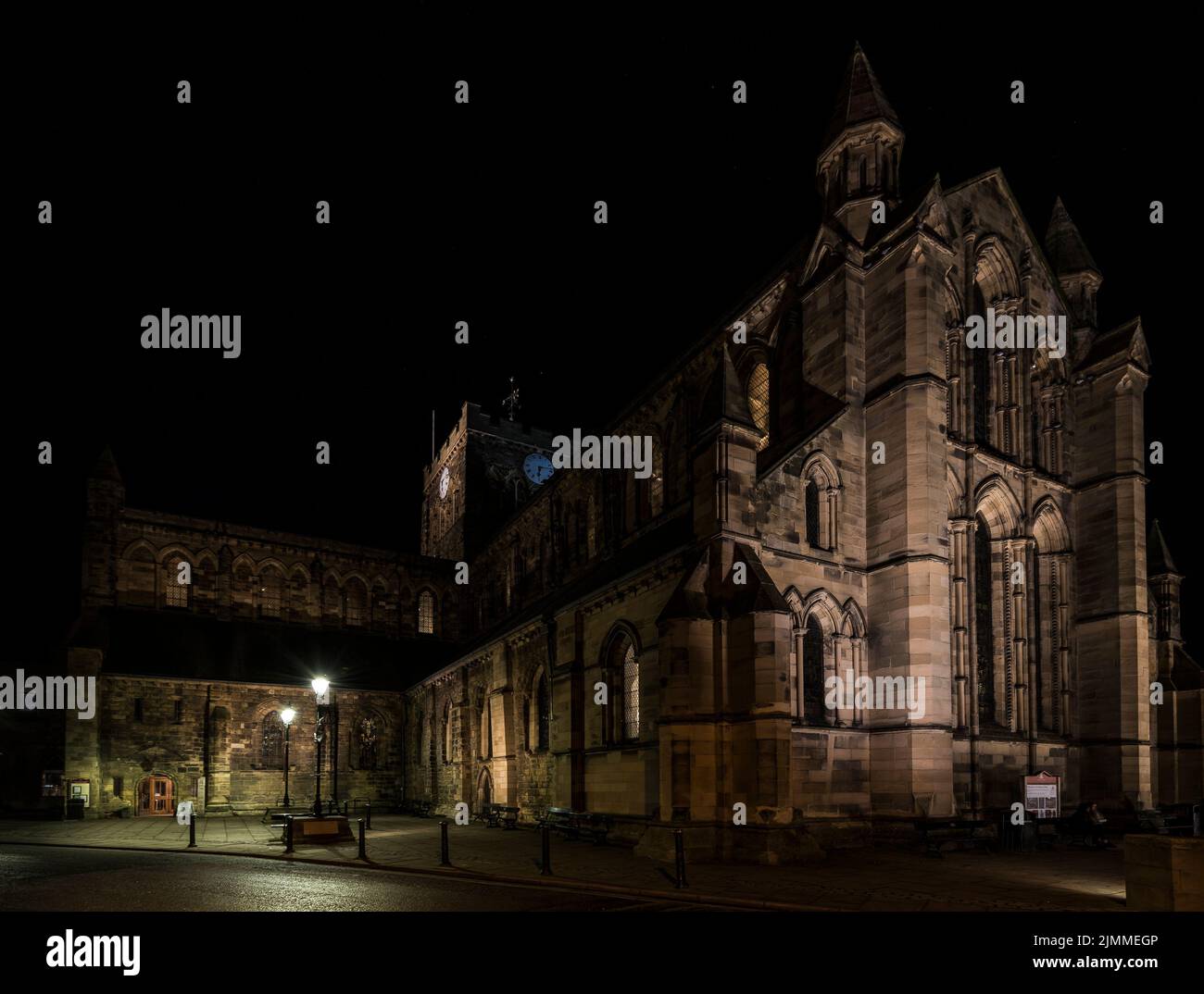 Night time street scene of Hexham Abbey floodlit against a black sky ...