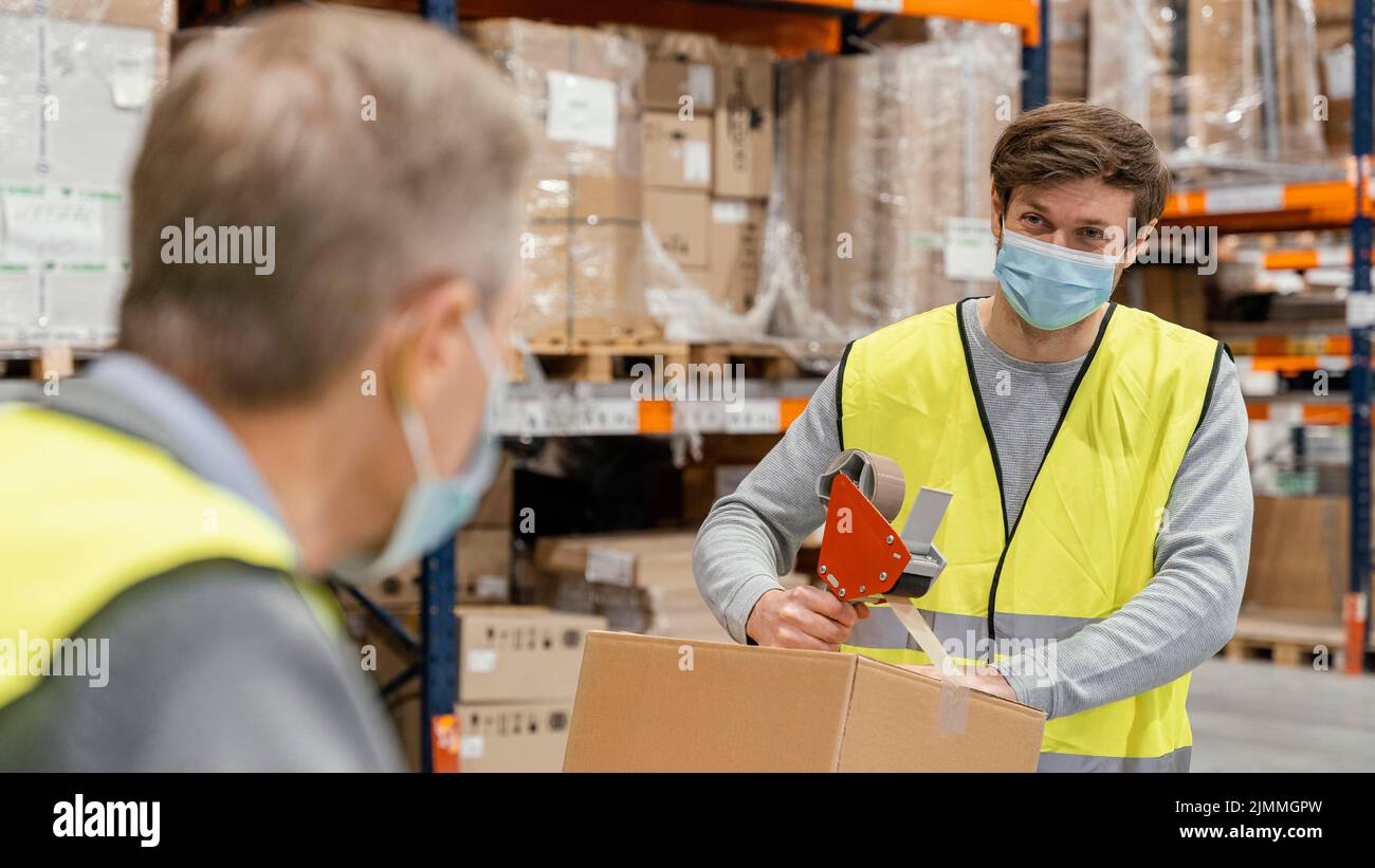 Men warehouse working Stock Photo - Alamy
