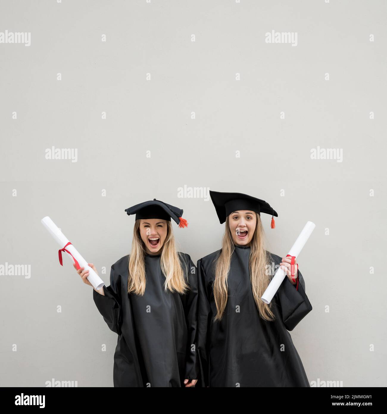 Medium shot happy girls graduating Stock Photo - Alamy