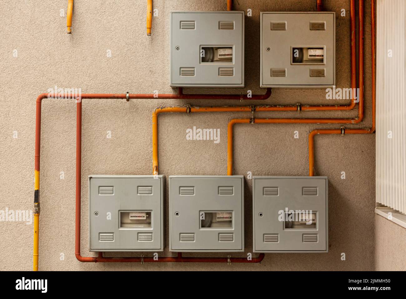 Concrete wall with meters pipes Stock Photo - Alamy