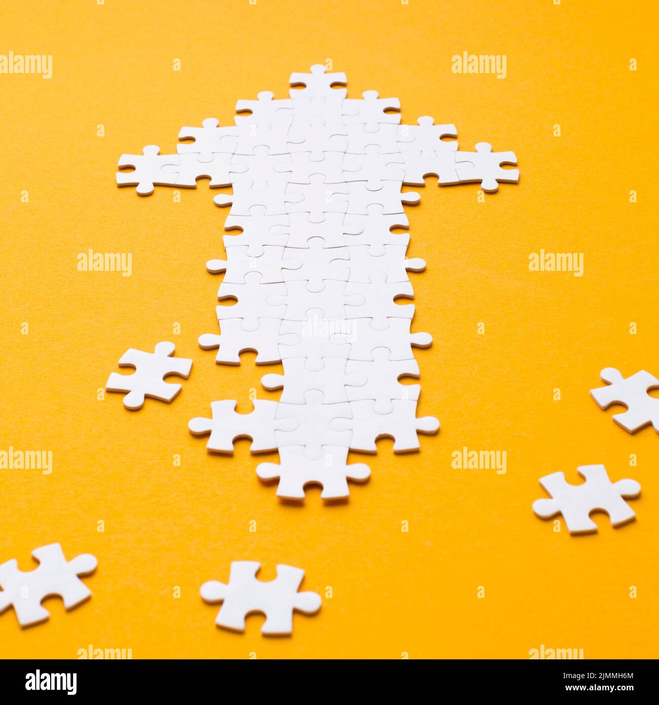 High angle puzzle pieces arrow Stock Photo - Alamy