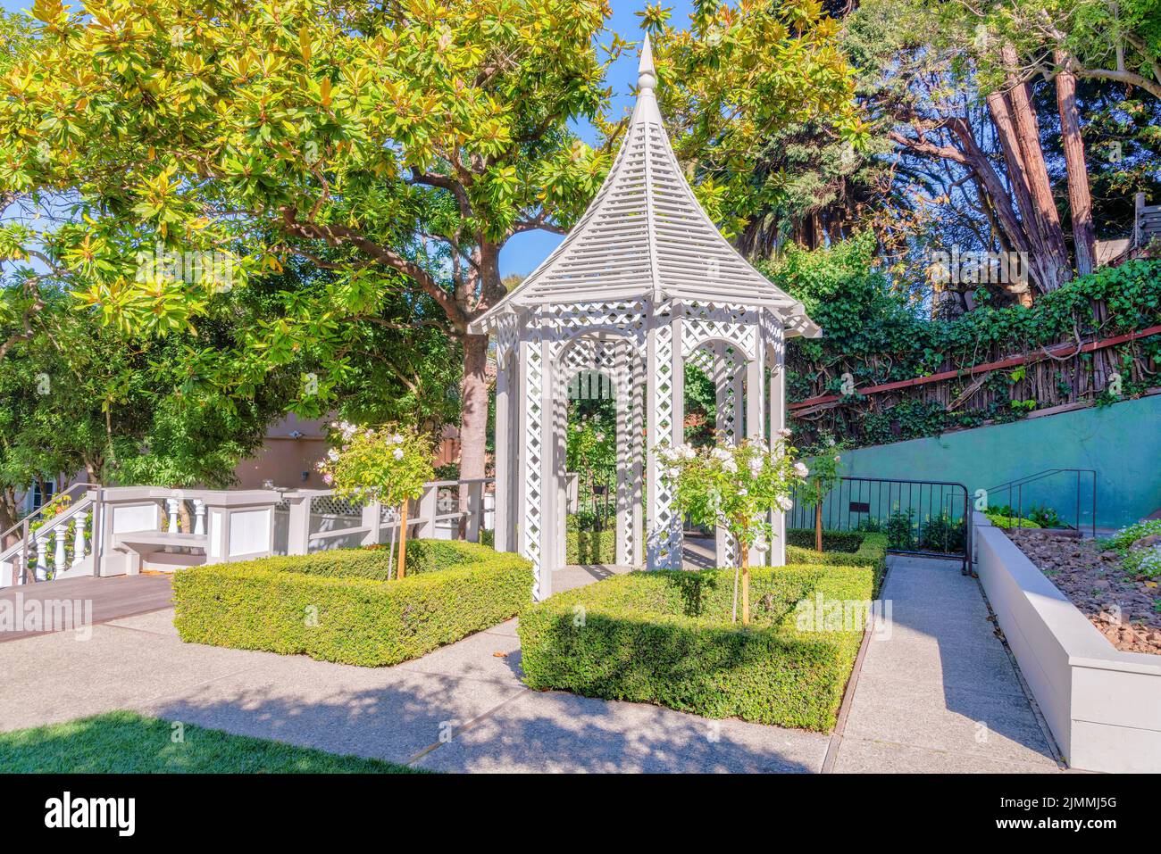 Small gazebo with pointed roof structure in the middle of bushes in San ...