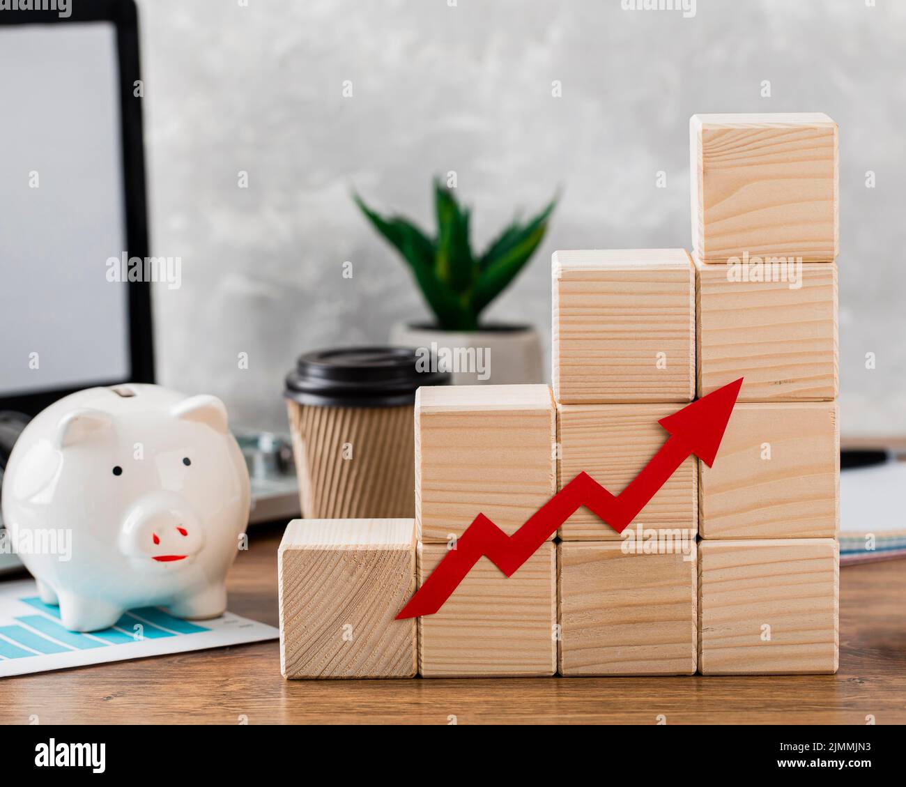 Piggy bank with wooden growth blocks Stock Photo - Alamy