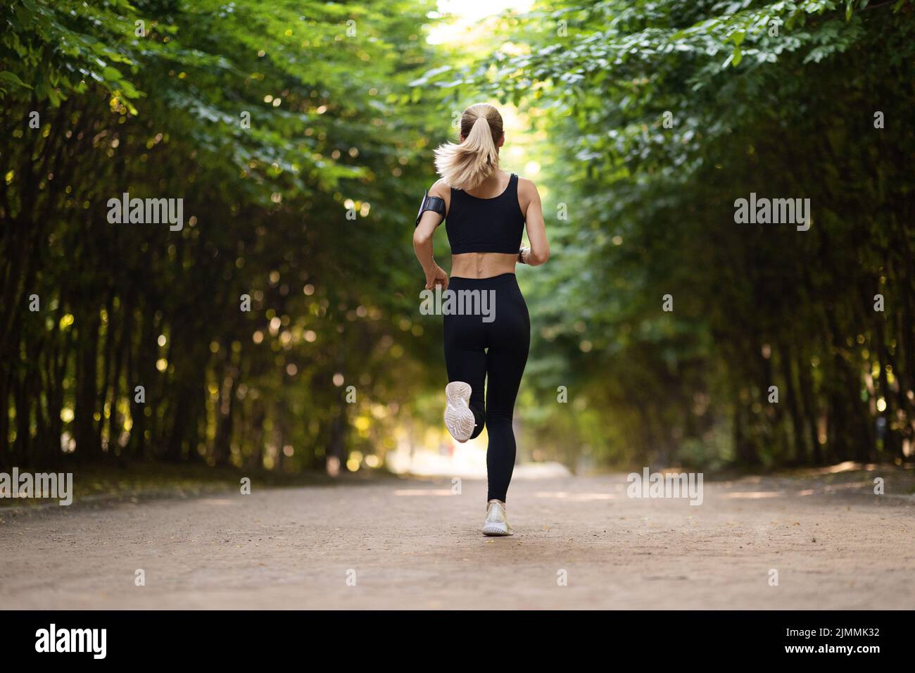 Back view woman jogging in hi-res stock photography and images - Alamy
