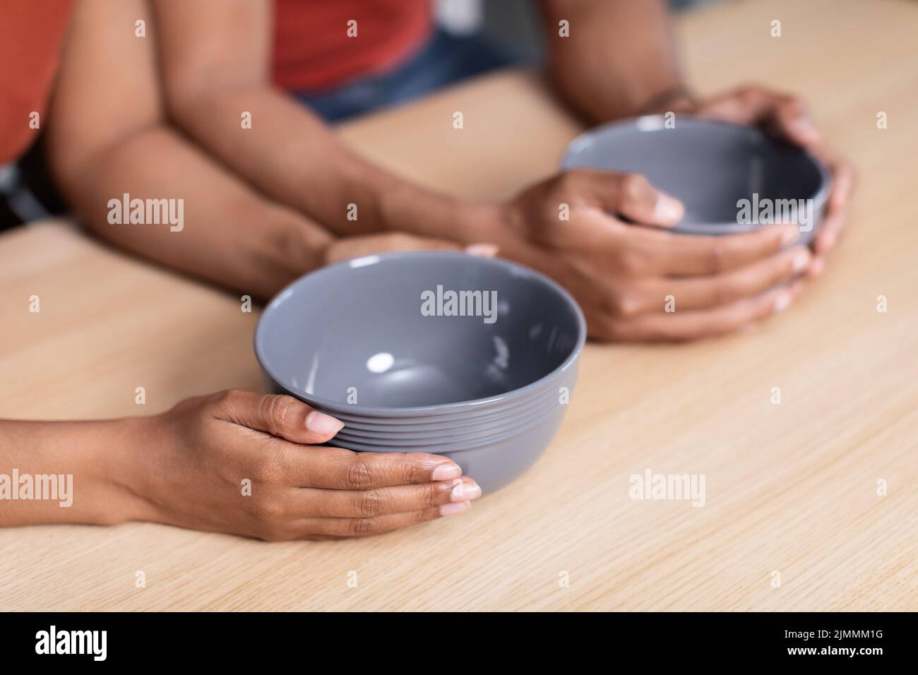 Hands of young starving african american wife and husband holding empty ...