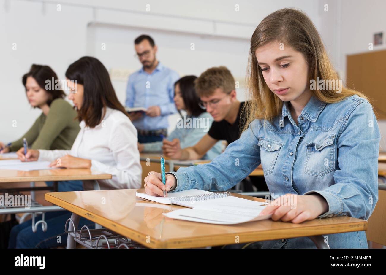Girl is writing test and answer about task Stock Photo - Alamy