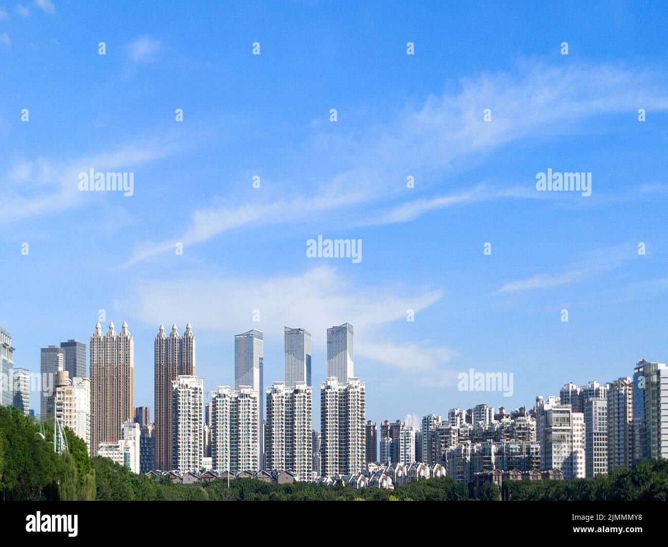 A stunning cityscape with white tall apartment buildings in daylight ...
