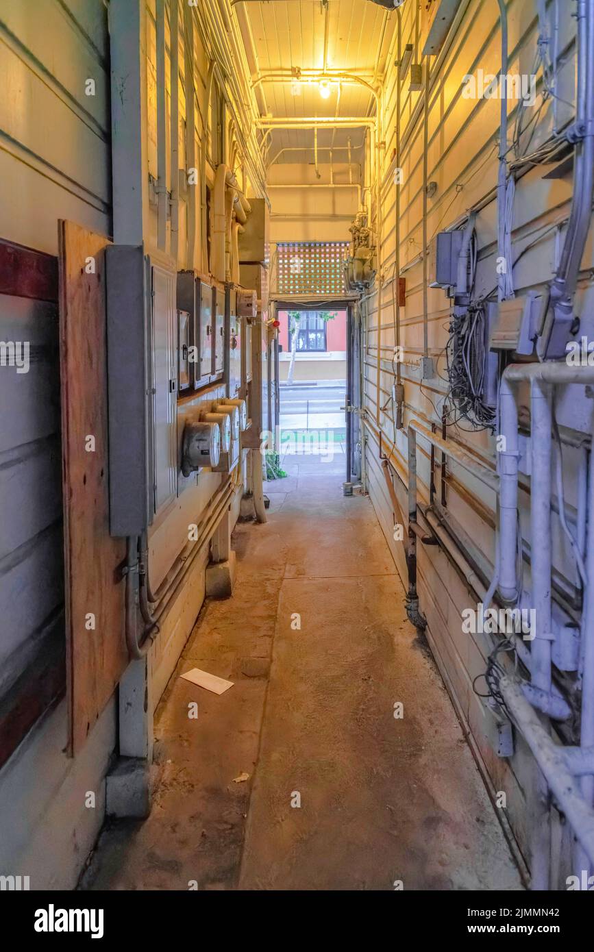 Concrete narrow way with ceiling and lights leading to the street in ...