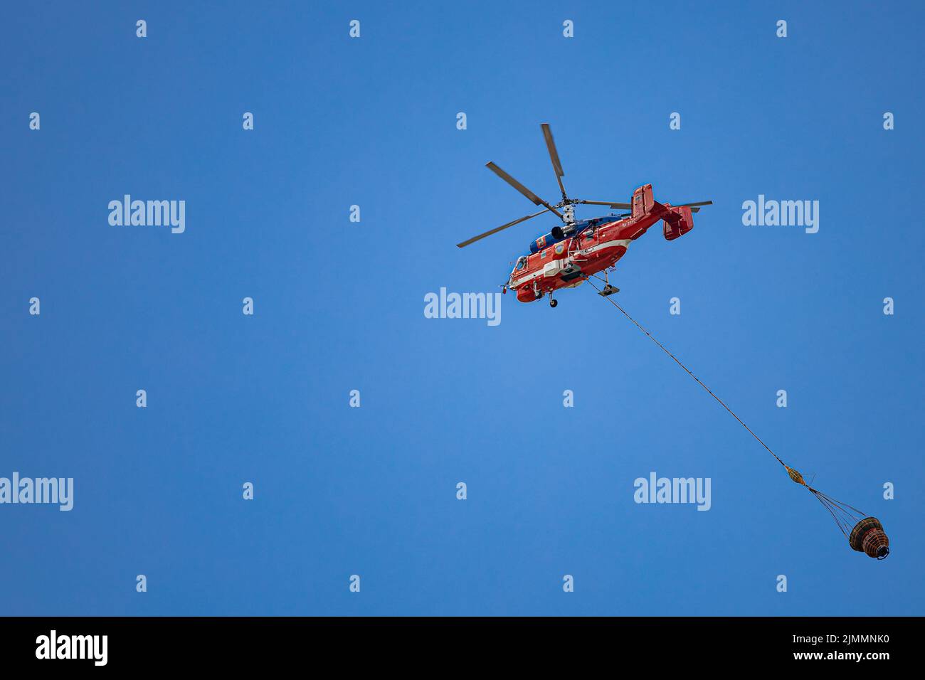 Moscow, Russia - July 21, 2022: helicopter carries cargo in a hanging ...