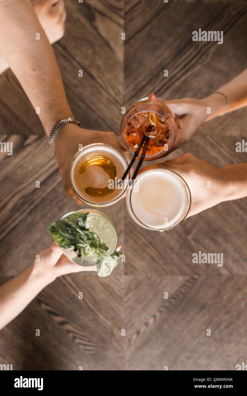 Overhead view friend hands toasting drinks Stock Photo - Alamy