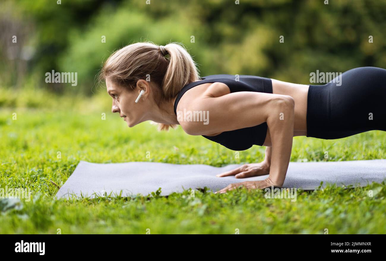 Motivated athletic woman standing in cobra pose Stock Photo - Alamy