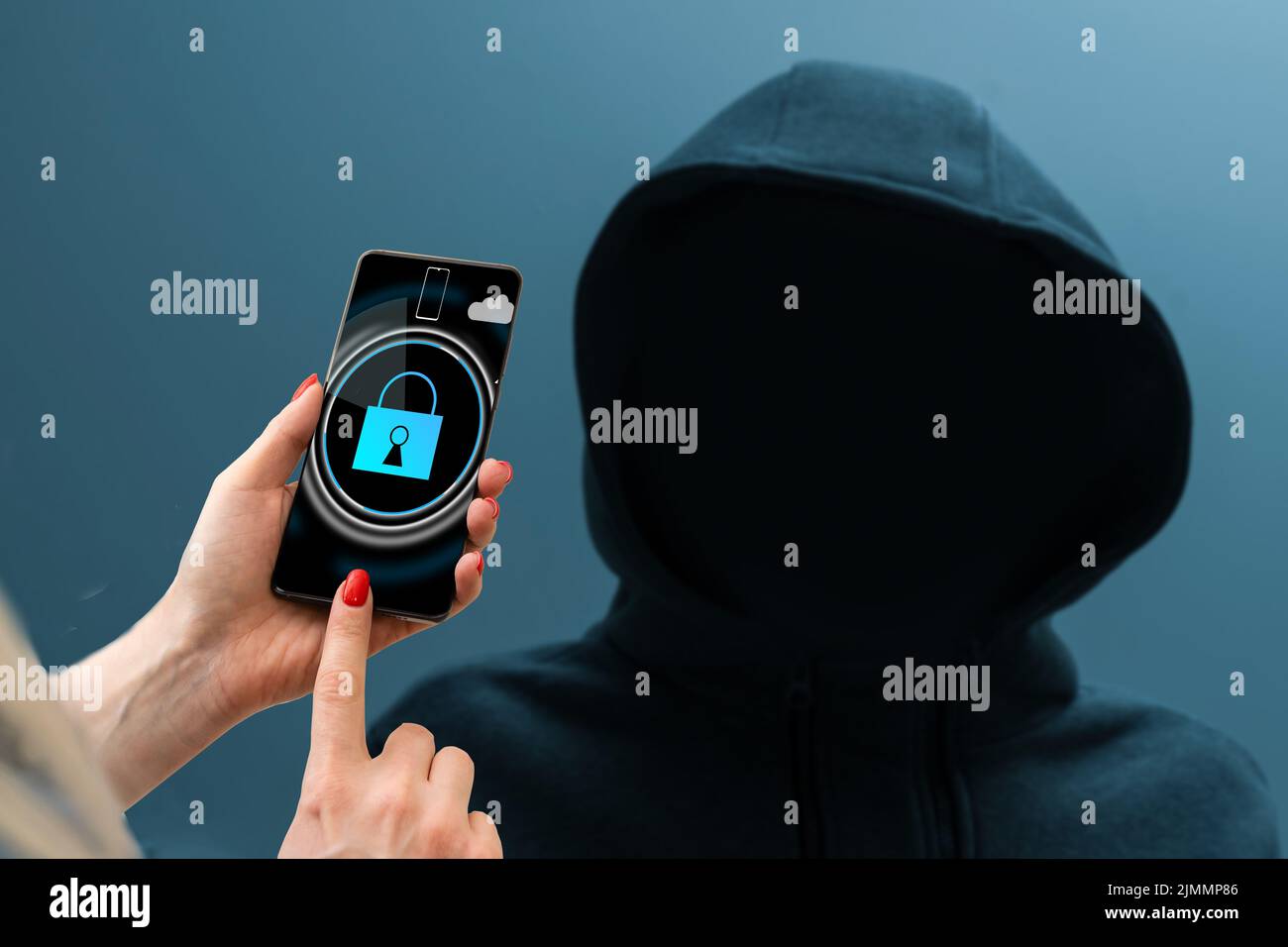 man in a hood Hacker, smartphone with a lock Stock Photo - Alamy