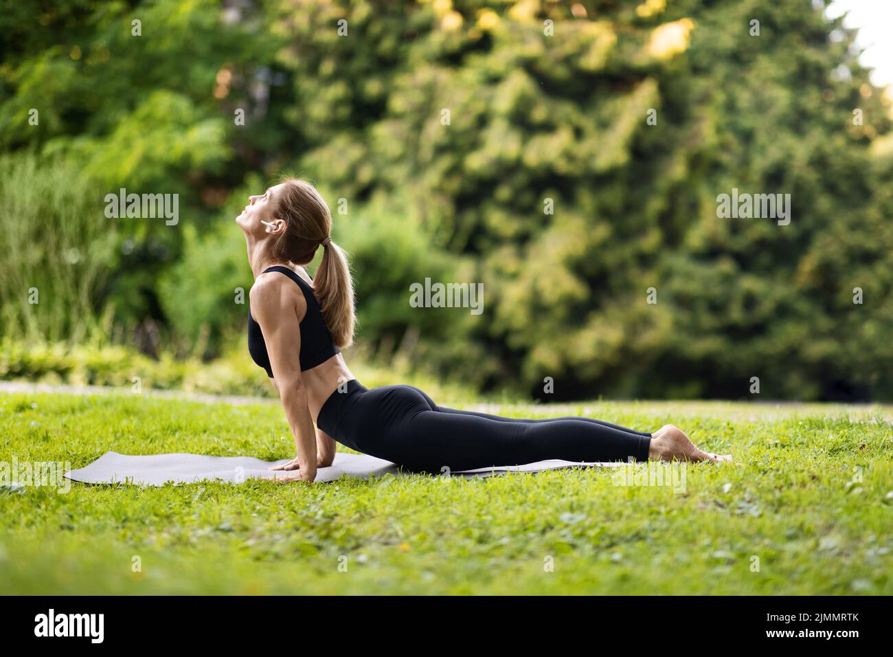 Side view of athletic woman standing in yoga pose Stock Photo - Alamy