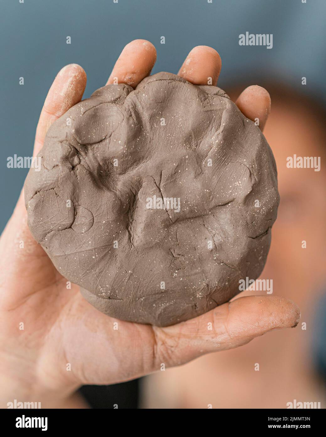 Close up hand holding clay Stock Photo - Alamy