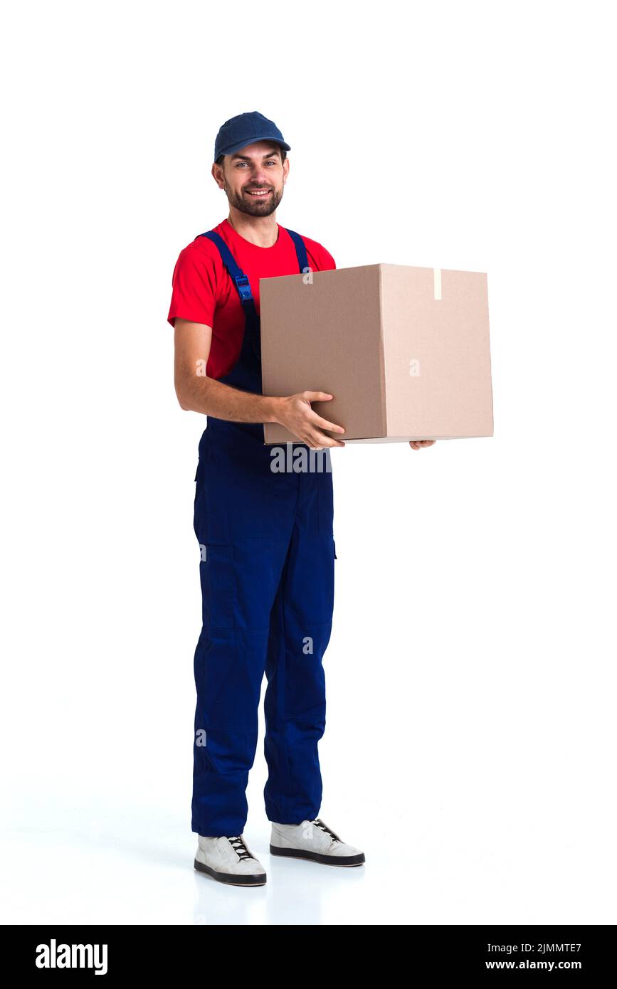 Hard worker courier man holding big box long view Stock Photo - Alamy