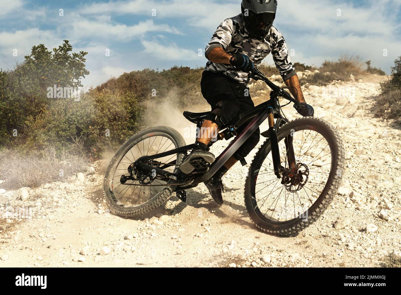 Professional bike rider during downhill ride on his bicycle Stock Photo ...