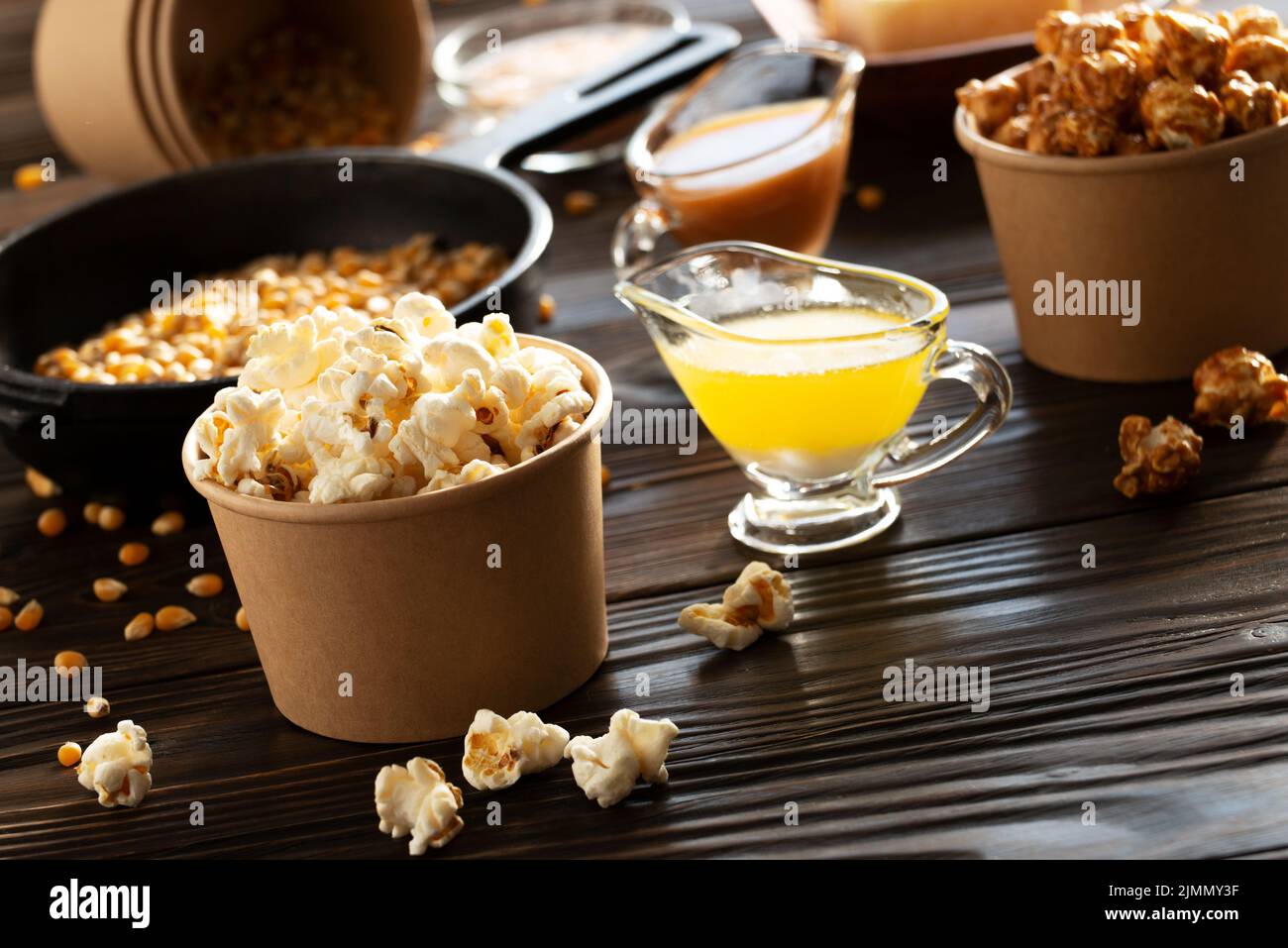 Paper buckets with butter and caramel popcorn on kitchen table Stock ...