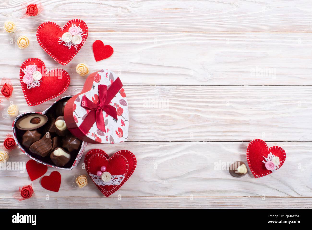 Chokolate box in shape of heart on white wooden table valentine ...