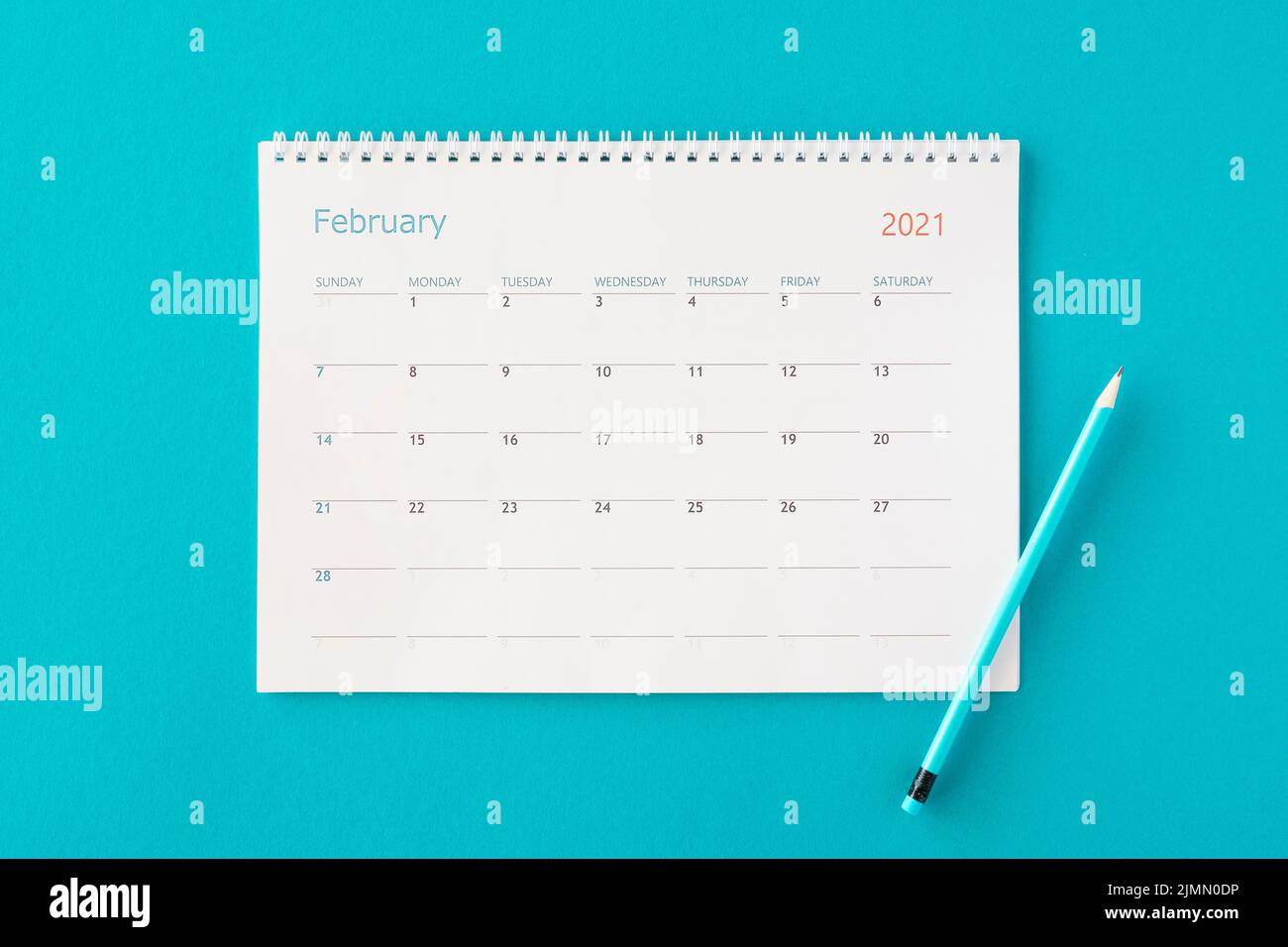 Flat lay planner calendar blue background Stock Photo - Alamy