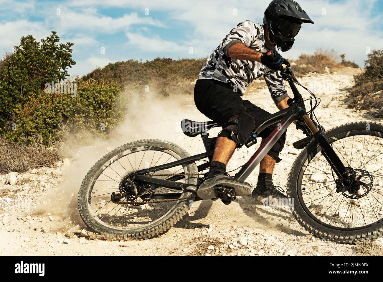 Professional bike rider during downhill ride on his bicycle Stock Photo ...