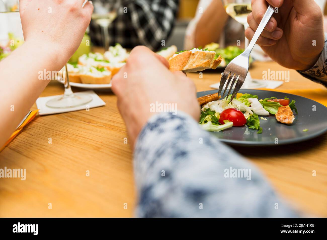 Crop hands man eating delicious dish Stock Photo - Alamy