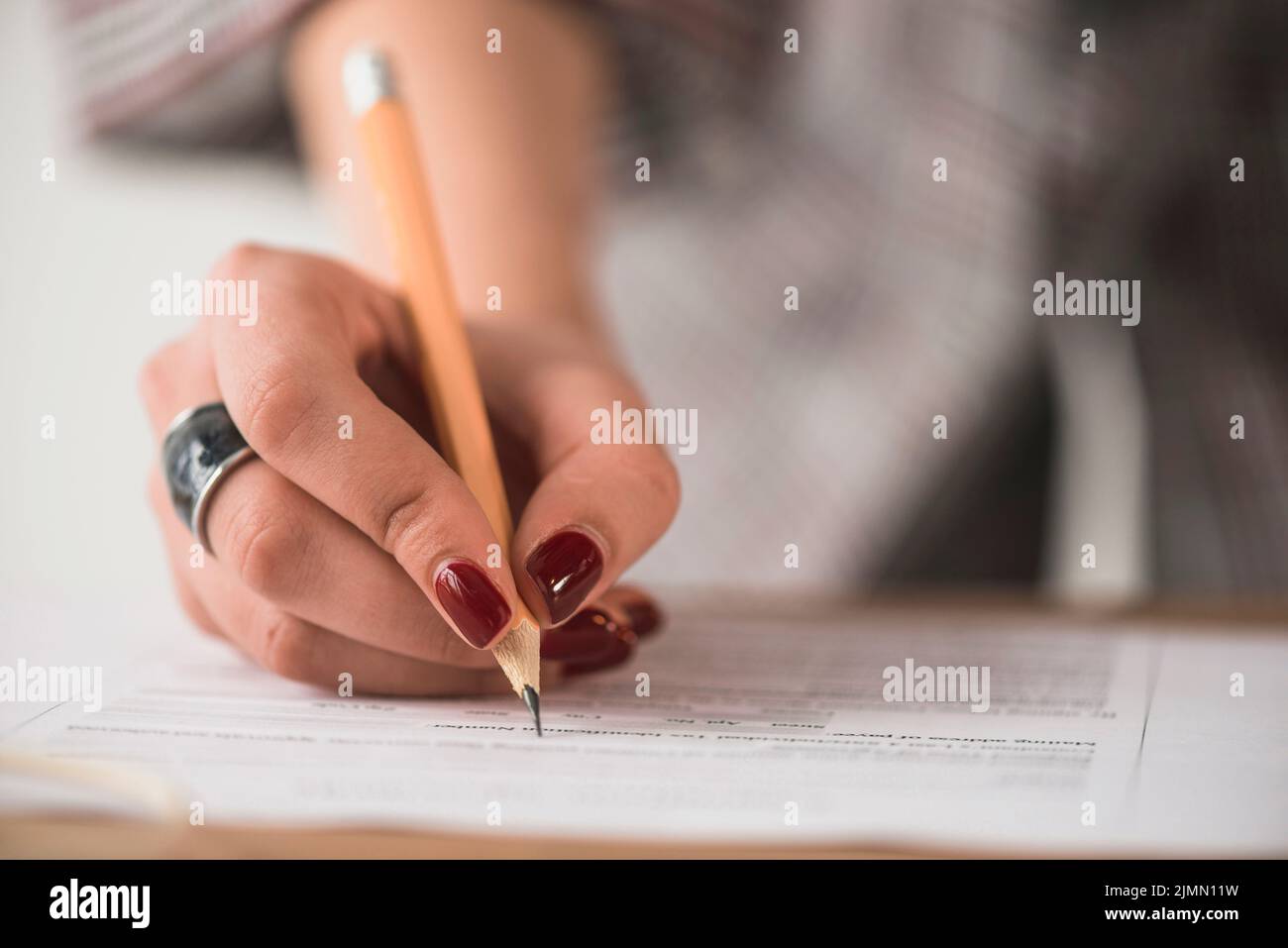 Crop hand filling document Stock Photo - Alamy