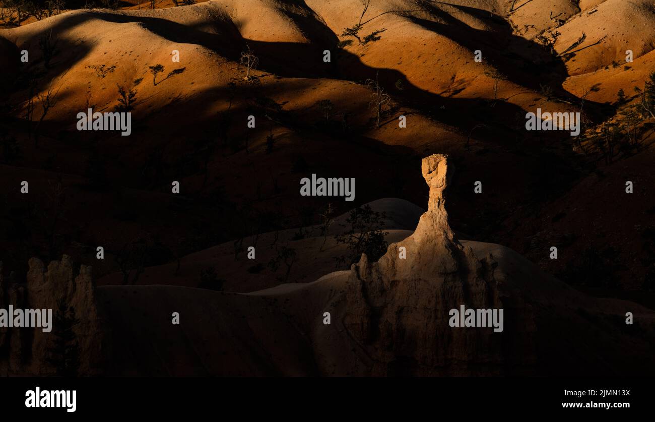 Illuminated Hoodoo over dark background in Bryce Canyon National Park ...