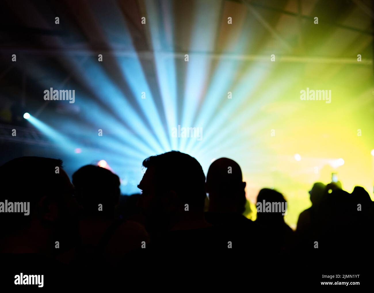 The crowd at concert with stage lights creating a starburst Stock Photo ...