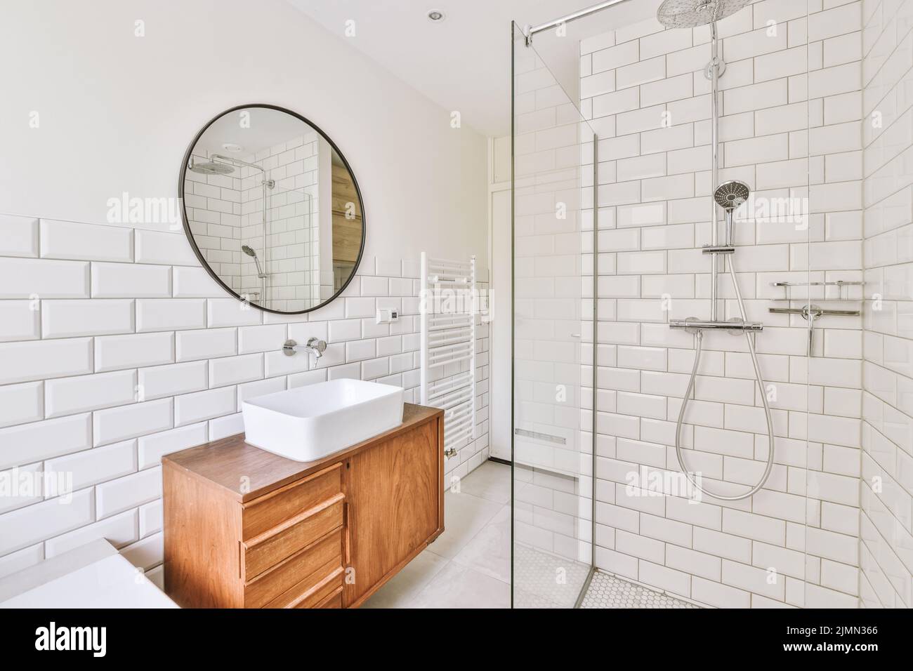 Sinks with mirrors and clean bathtub,washing machine located near ...