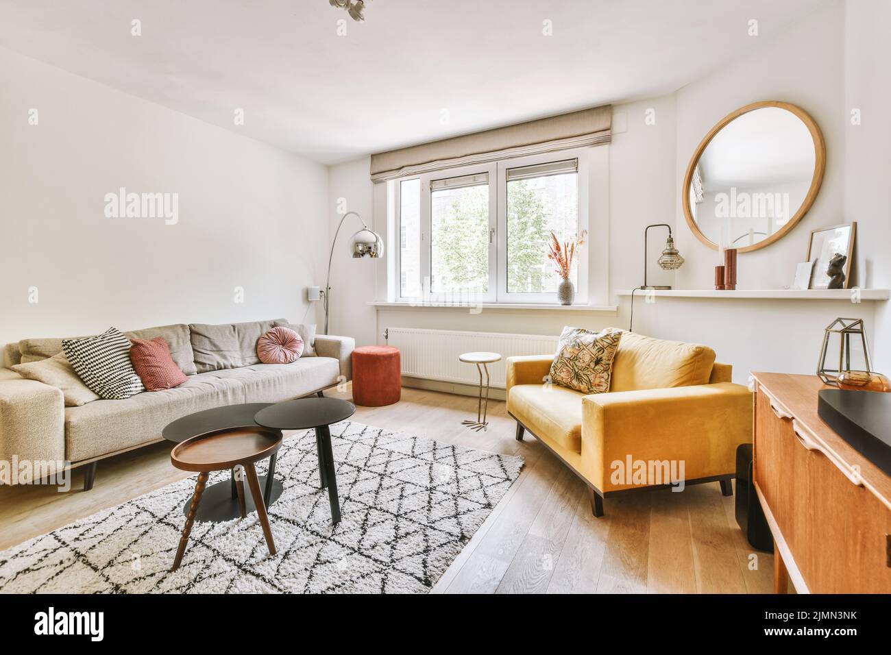 Interior of living room with comfortable sofa and TV against windows in ...