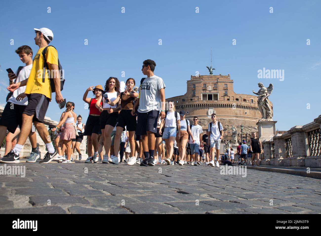 Rome, Italy. 7th Aug, 2022. Young tourists walk on Sant'Angelo Bridge ...