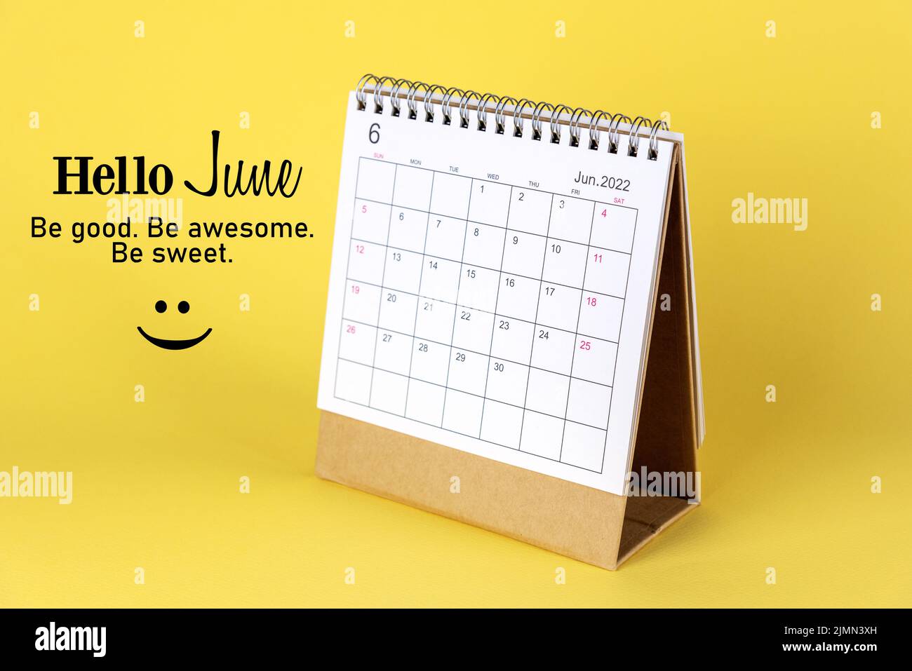 June 2022 calendar on wooden rustic table with positive text message ...