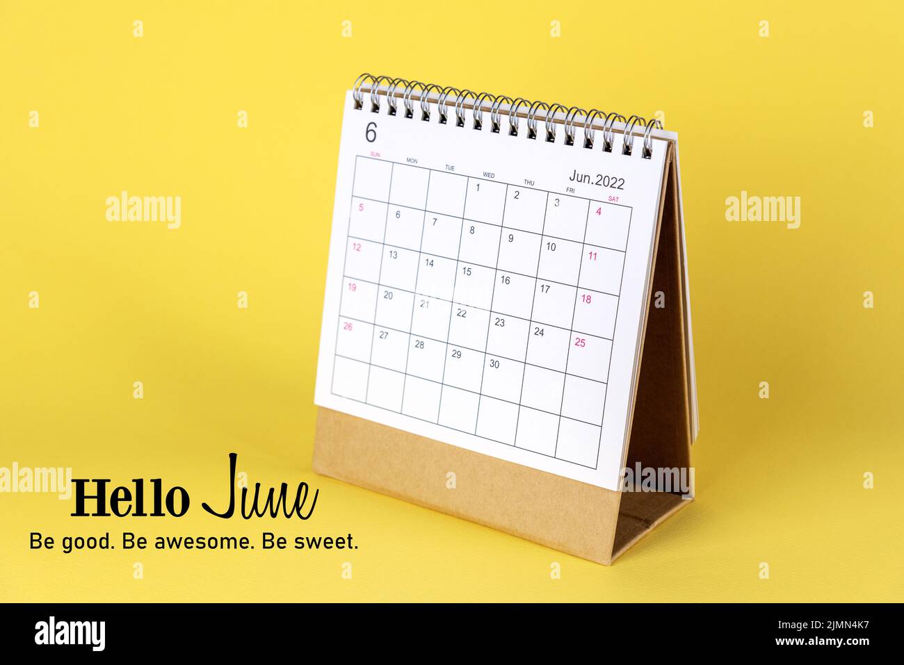 June 2022 calendar on wooden rustic table with positive text message ...