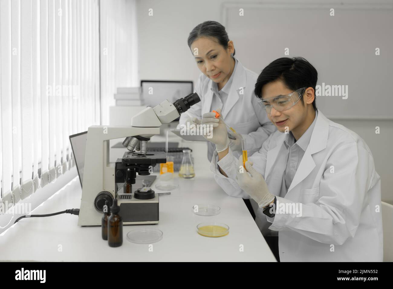 Scientist holding a test tube containing cannabis extract Stock Photo ...