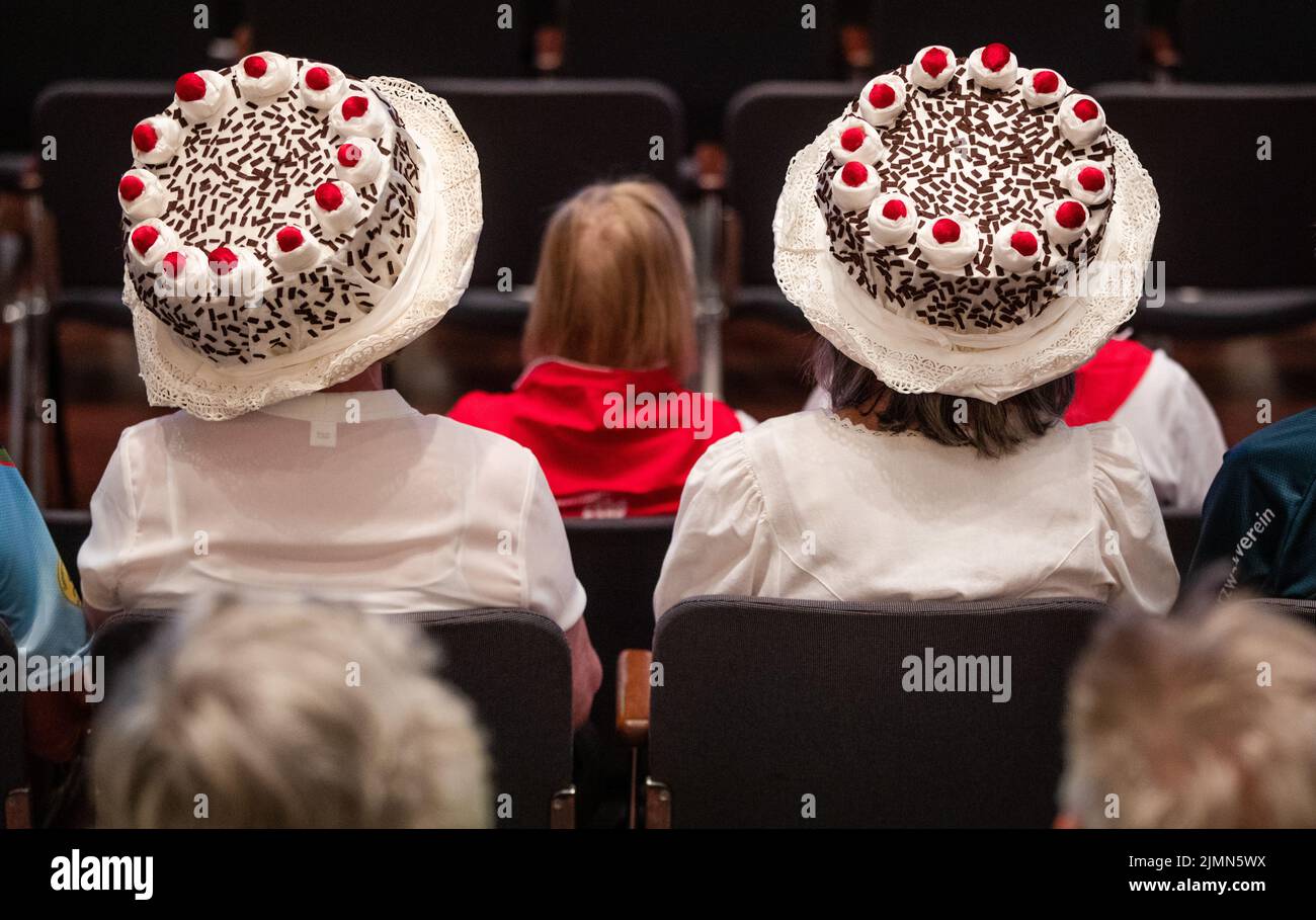 Fellbach, Germany. 07th Aug, 2022. Two women wear hats in the shape of ...