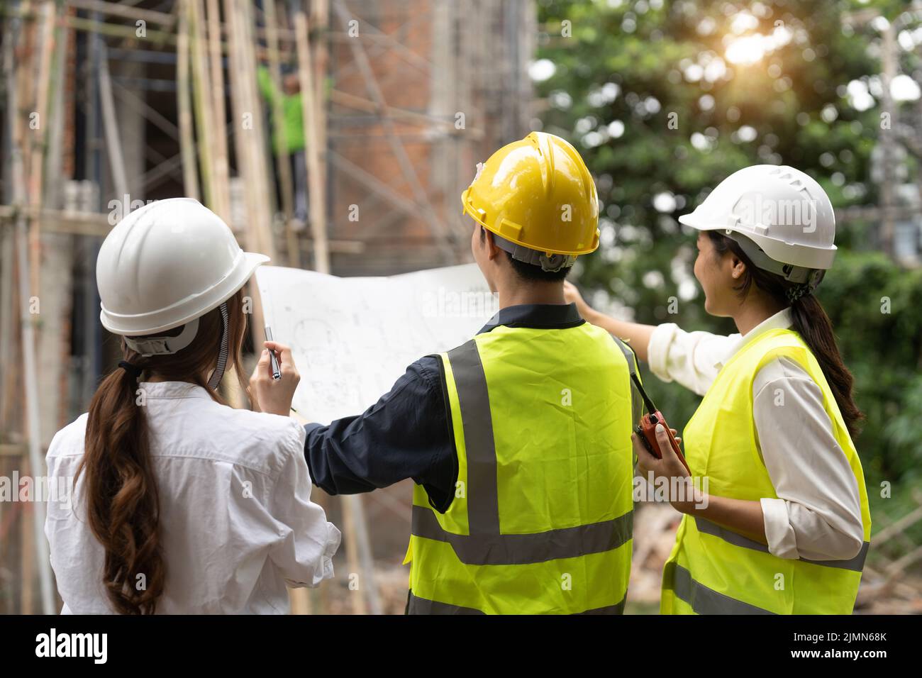 Engineer and Architect working at Construction Site with blue print ...
