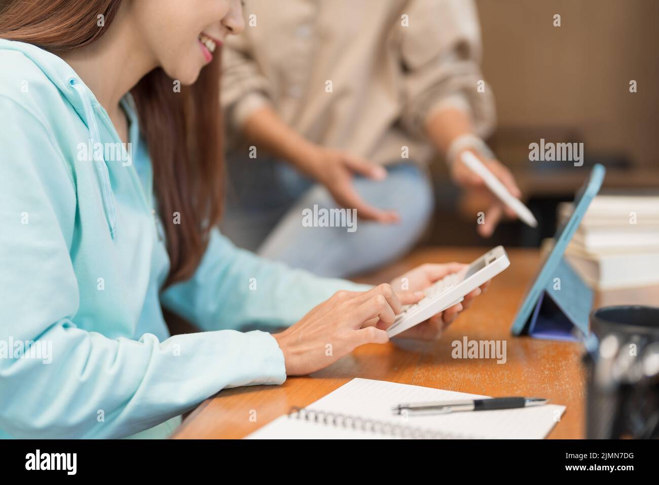 Education concept, Teenage girl use calculator to doing math quiz while ...