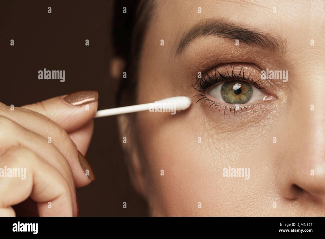 Female face and cotton swab. Hygiene or makeup corrections Stock Photo ...