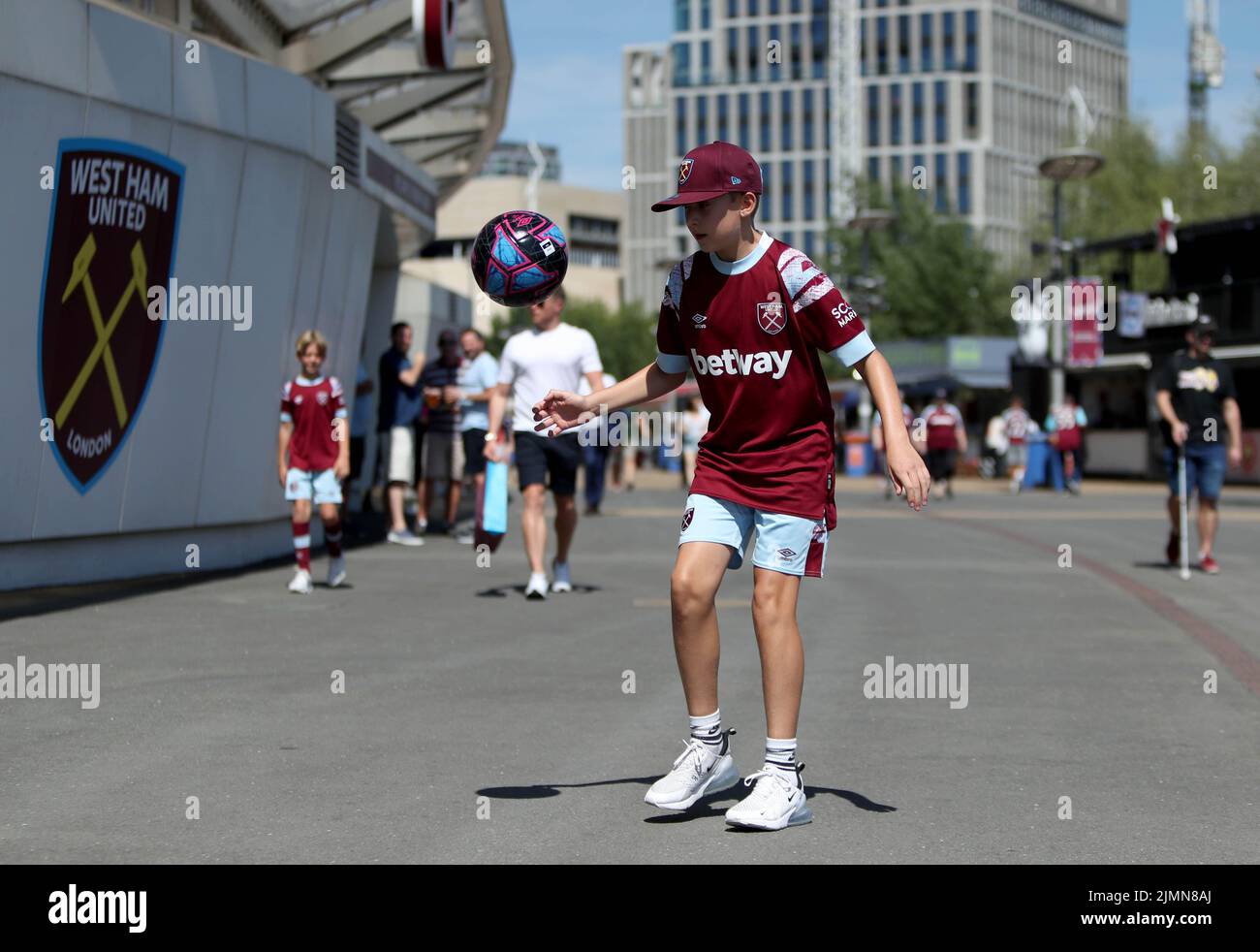 A West Ham United fan plays football outside the ground before the ...